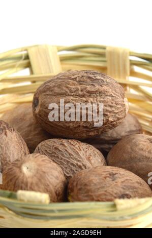 Nutmeg in bamboo basket isolated on white background Stock Photo - Alamy