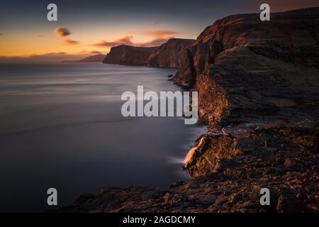 Bosdalafossur waterfall on Vagar island coastline in sunset, Faroe ...
