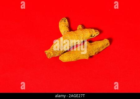 Barks of Yellow Turmeric on Red Background Stock Photo - Alamy