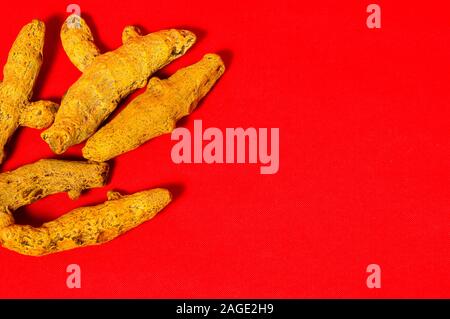 Barks of Yellow Turmeric on Red Background Stock Photo - Alamy