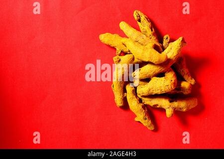 Barks of Yellow Turmeric on Red Background Stock Photo - Alamy