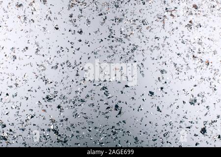 Silver falling confetti on metallic backdrop. Festive and party concept ...