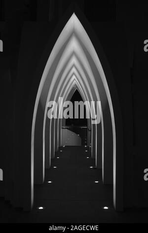 Vertical shot of a building with arch-shaped green windows and a door ...