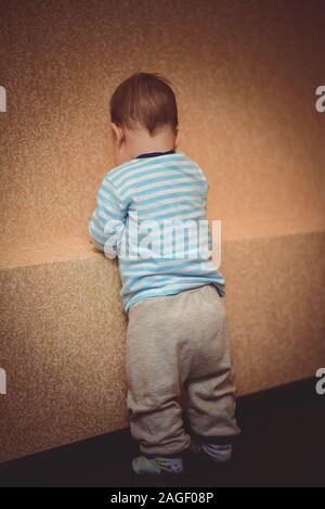 Child standing in the corner, facing the wall Stock Photo - Alamy