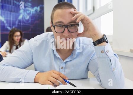 Youngmale student in math class overwhelmed by the math formula ...