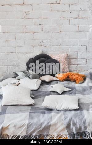 Cozy place for rest with soft pillows and book near window Stock Photo ...