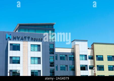 Hyatt House hotel sign with logo in landscaped parking area on a sunny ...