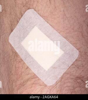 Band aid on skin, hairy leg, adult Stock Photo - Alamy
