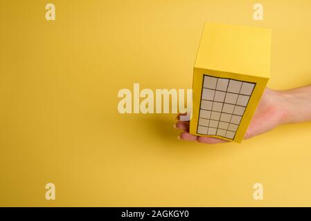 Yellow paper block of flats on yellow background paper. Minimalistic ...