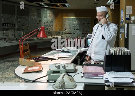 Chernobyl reactor 3 control room. Worker sat at the control panel of ...