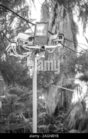 A cluster of CCTV cameras on a post keeping the security of a housing ...