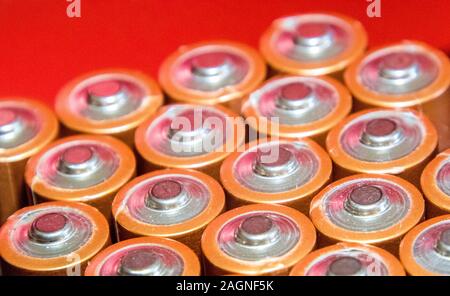 A collection of pencil AA batteries, taken close up at their heads ...