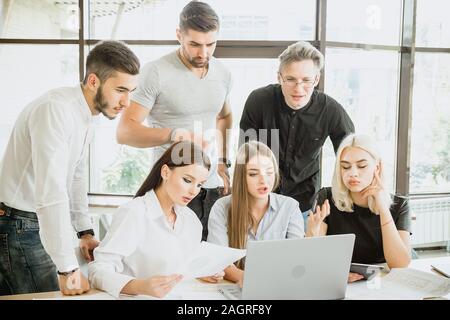Group of people in front of a laptop, security concept Stock Photo - Alamy
