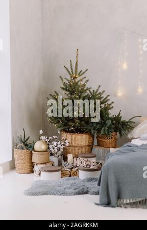 Beautiful Christmas tree, comfortable bed and festive decor in bedroom ...