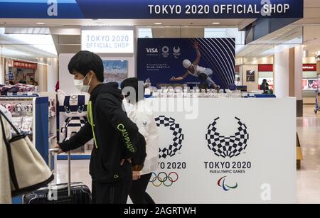 Travelers walked pass a 2020 Tokyo Olympics and Paralympics official ...