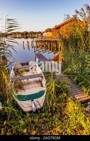 Boats at floating village Bokodi in Hungary at sunrise. These houses ...