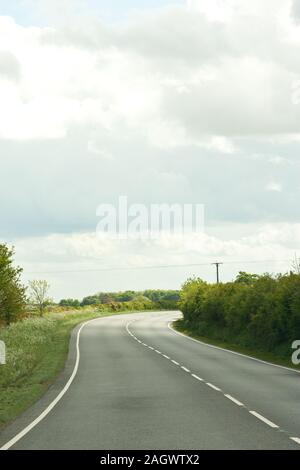 A road weaving it's way through the countryside, in the United Kingdom ...
