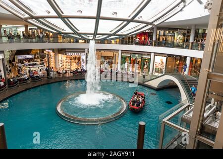 Boats on the internal canal at the Marina Bay Sands shopping Mall in ...