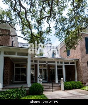 Colonial home with white columns and American flag in New Orleans Stock ...