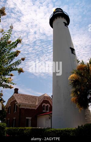 Scenic view of lighthouse located on shore of rippling sea against blue ...