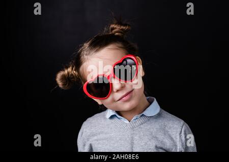 small smiling boy or cute nerd kid in glasses, hat and fashionable ...