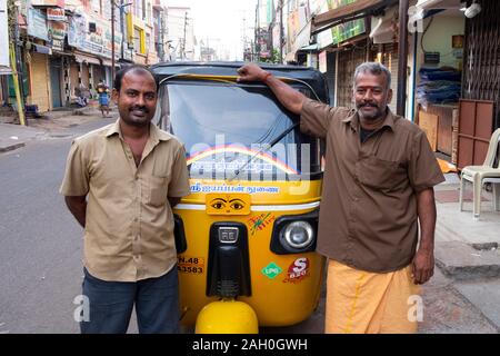 Portrait of an auto rickshaw driver looking back while driving Stock ...