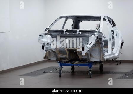 Custom car being build in workshop. Sports car body, car frame is ...