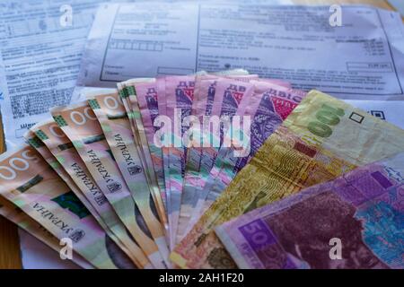 Ukrainian money hryvnia and coins penny wooden background, utility bill ...