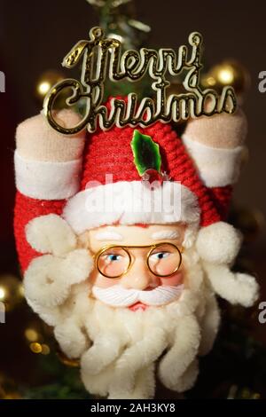 A closeup of a red Merry Christmas card with a wooden snowman ...