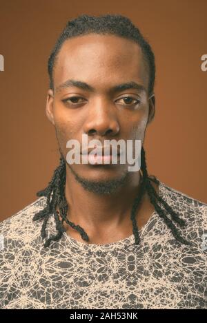 Young african man with dreadlocks wearing business jacket over white ...
