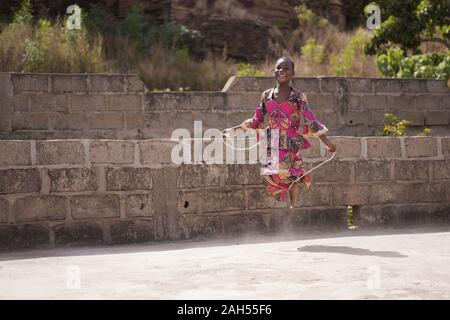 Jumping rope child in Africa, rope skipping African boy Stock Photo - Alamy