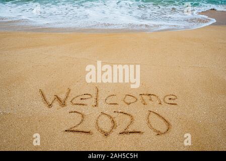 Welcome 2020 written in the sand- New Year concept Stock Photo - Alamy