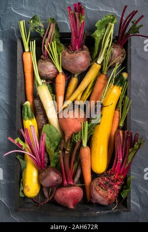 Seasonal harvest produce. Flat-lay of fresh raw uncooked purple ...