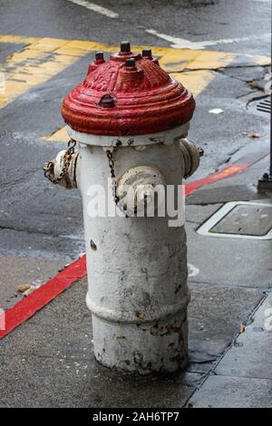 Red pillar-type fire hydrant for emergency fire access in a street ...