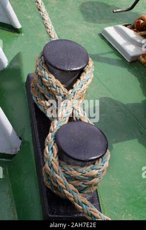 mooring equipment of ship. Mooring lines are fast on bollards, capstan ...