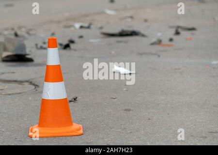 Yellow plastic cone placed on a street at car accident crash site Stock ...