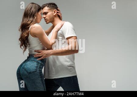 dancers in denim jeans dancing bachata on grey background Stock Photo ...