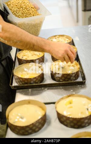 pasty chef strong adult man chef preparing and decorating panettone for ...