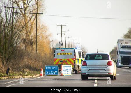 Police have coned off a lane of a busy main road, in the United Kingdom ...