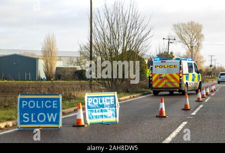 Police have coned off a lane of a busy main road, in the United Kingdom ...