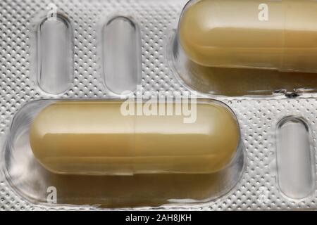 Brown capsules pill in blister pack arranged with beautiful pattern ...