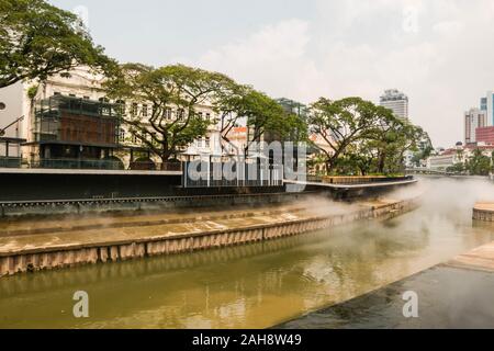 A beautiful view of Jamek Mosque with green plants and an information ...