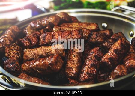Traditional romanian barbecue with minced pork meat rolls (mici or ...