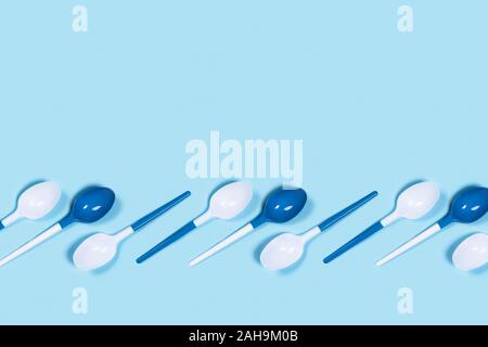 Dangerous plastic spoons. Environmental problem of plastic rubbish ...