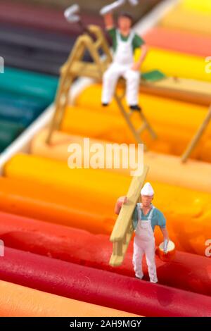 Miniature scale model painters and decorators with ladders on a set of ...