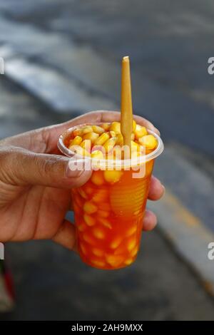 Holding a cup of corn at a street food stand Stock Photo - Alamy