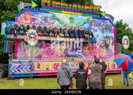 People watching the Cliffhanger fairground ride and a children's tea ...