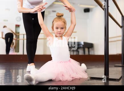 Little ballerina practicing front splits Stock Photo - Alamy