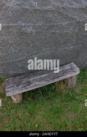 Huge boulder and old bench in the garden Stock Photo - Alamy