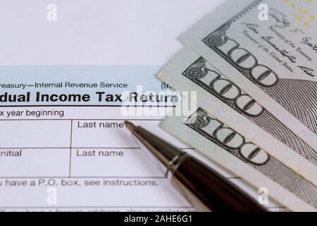 Economic stimulus tax 1040 form and US 100 dollar bills currency Stock ...